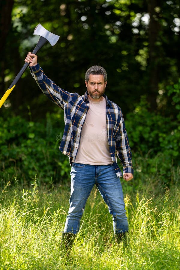 Lumberjack in the Forest. Man with Ax. Serious Lumberjack. Bearded Man ...