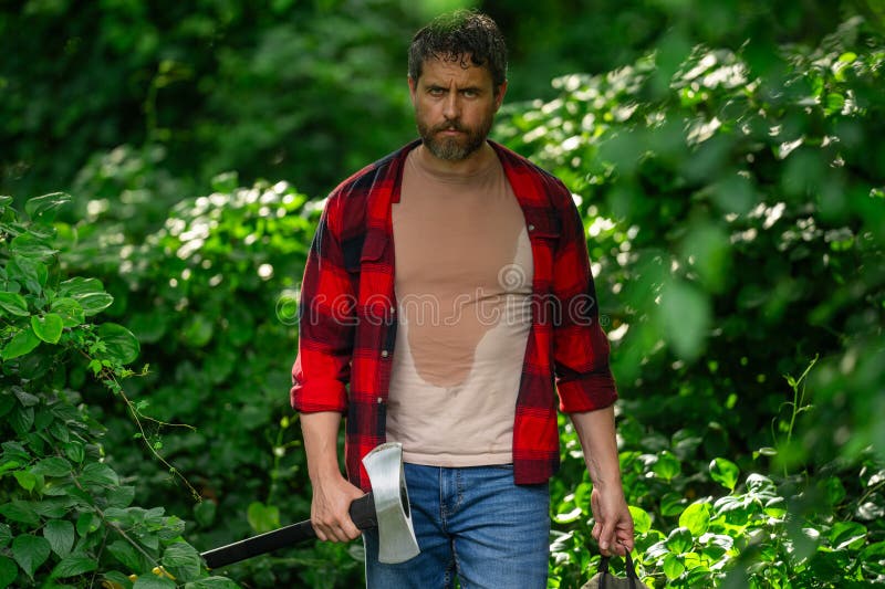 Lumberjack in the Forest. Man with Ax. Serious Lumberjack. Bearded Man ...