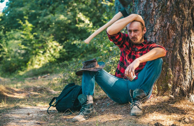 Lumberjack Man Sitting in the Forest. Illegal Logging Continues Today ...