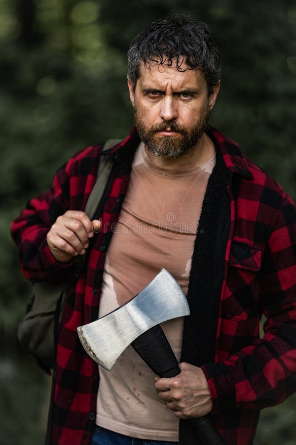 Lumberjack In The Woods With An Axe Bearded Man In Hat With A Hatchet