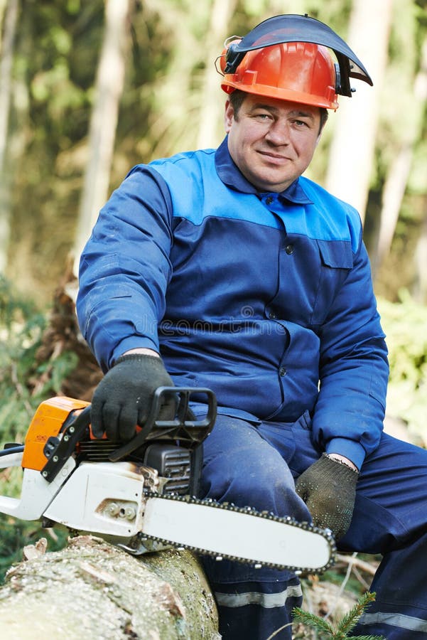 Lumberjack Worker with Chainsaw in the Forest Stock Image - Image of ...