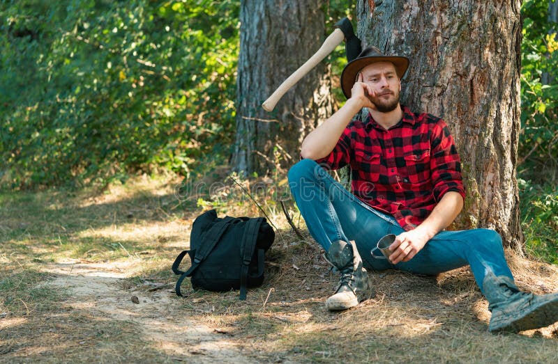 Lumberjack Worker Sitting in the Forest. Lumberjack in the Woods with ...