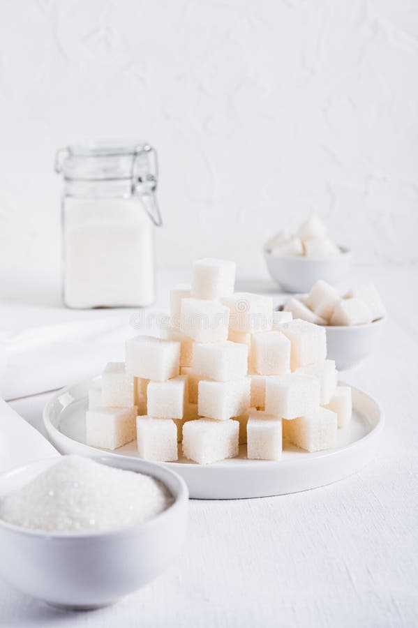 Lump Sugar on a Plate and Granulated Sugar in a Bowl and Jar on the ...