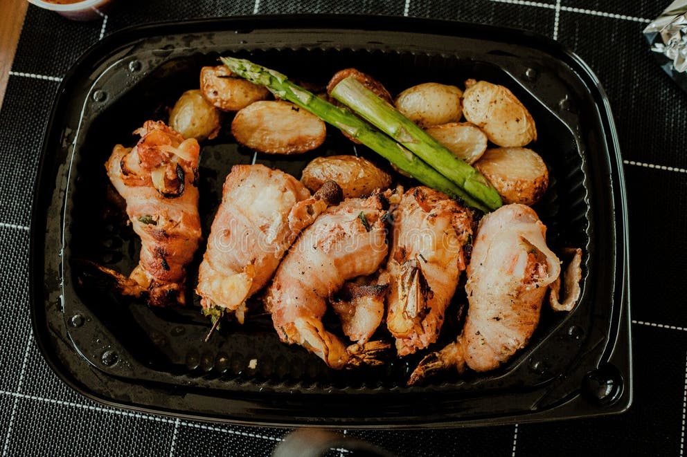 Lunch Box Containing Prawns, Asparagus and Potatoes on the Table Stock ...