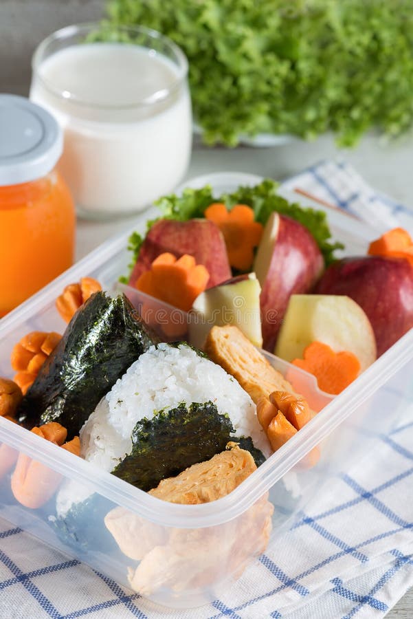 Lunch Box, Rice Wrapped in Seaweed with Sausage, Egg and Apple. Stock ...