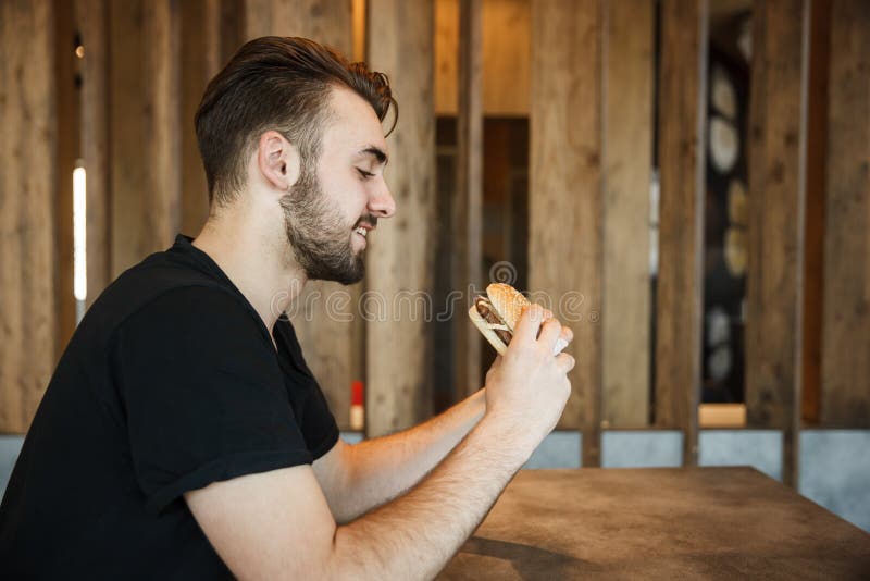 Lunch at the Cafe. a Young Guy Looks at the Burger and Wants To Sit ...