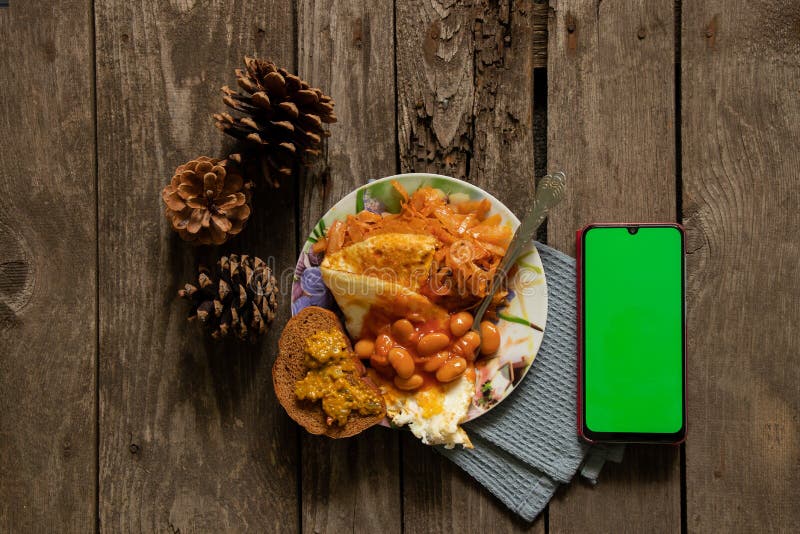 Lunch Plate with Fried Egg and Salad and a Phone with a Green Screen on ...