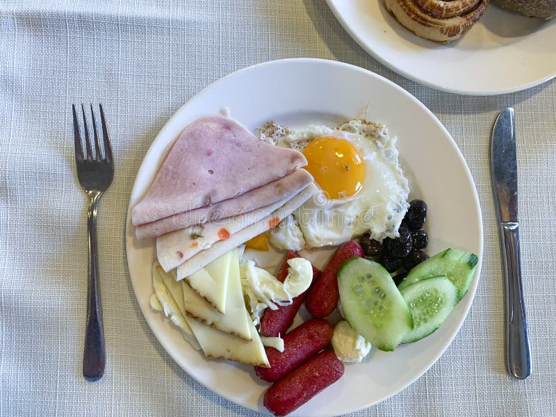Lunch. Plates of Eggs, Ham, Cheese and Vegetables on Table Stock Photo ...