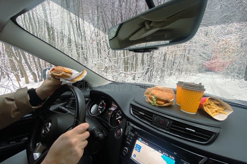 Lunch Stop in the Winter Forest, a Happy Man Eats while Driving a Car ...