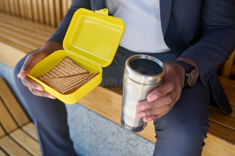 A Man Sitting on the Bench and Having Lunch Stock Photo - Image of ...