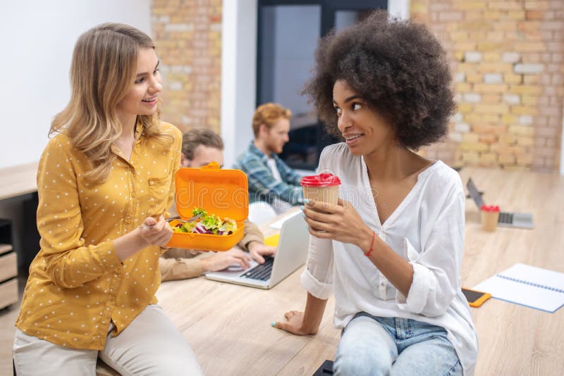 Two Female Colleagues Eating Lunch Together and Talking Stock Image ...