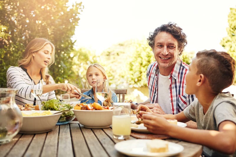 Lunch Together is Just Better. a Family Eating Lunch Together Outdoors ...
