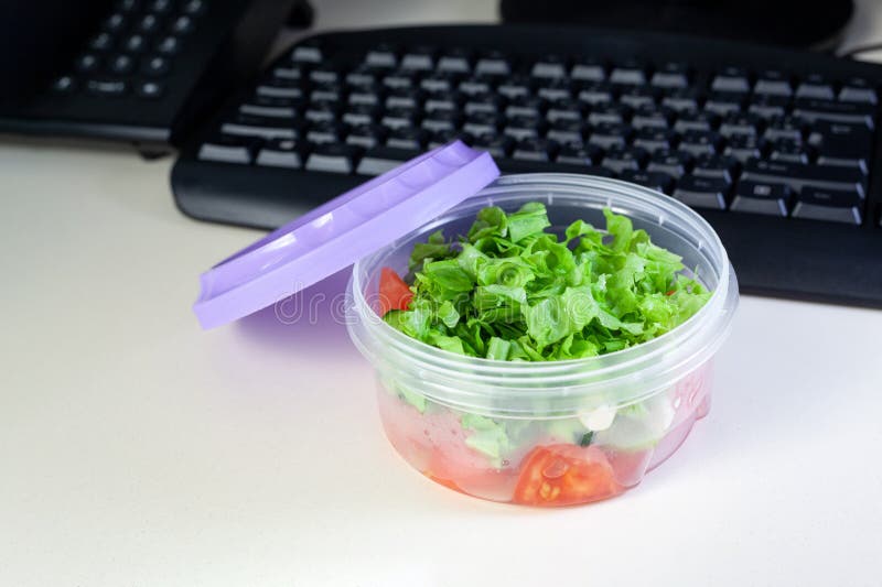 Lunch on Work Place. Food Box Container with Fresh Salad on the Working ...