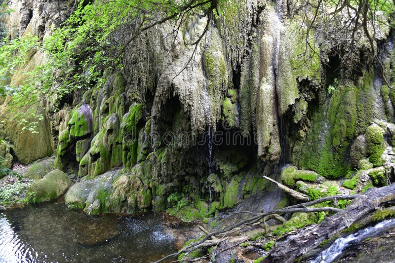 Moss-covered Rock Formation with Waterfall in Forest Stock Photo ...