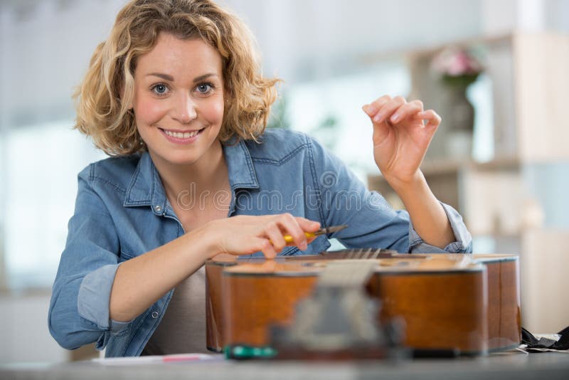 Luthier Apprentice Cleans Concert Guitar with Care Stock Photo - Image of craftsman, tool: 269021876