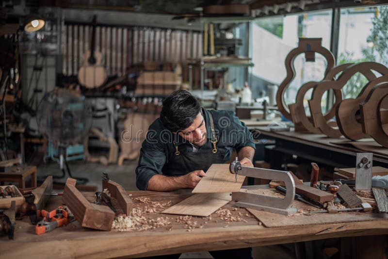 Luthier Creating a Guitar and Using Tools in a Traditional Stock Image ...