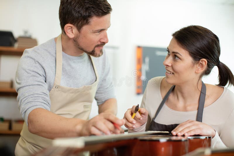 Luthier and Guitar Maker Apprentice Work on Acoustic Guitar Stock Image ...