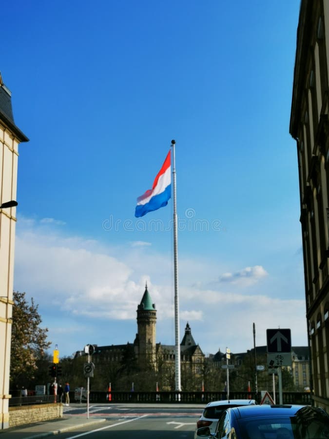 Luxembourg Flag Swaying in the Wind in a Square Stock Photo - Image of ...