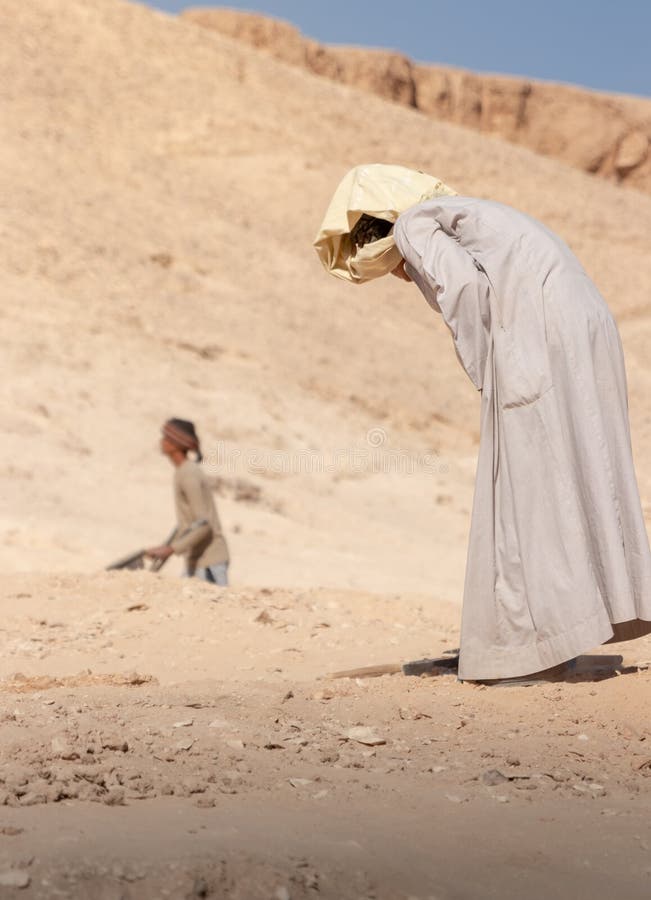 LUXOR, EGYPT - 27 Dec 2022. Vertical View of Two Men Working Under the ...