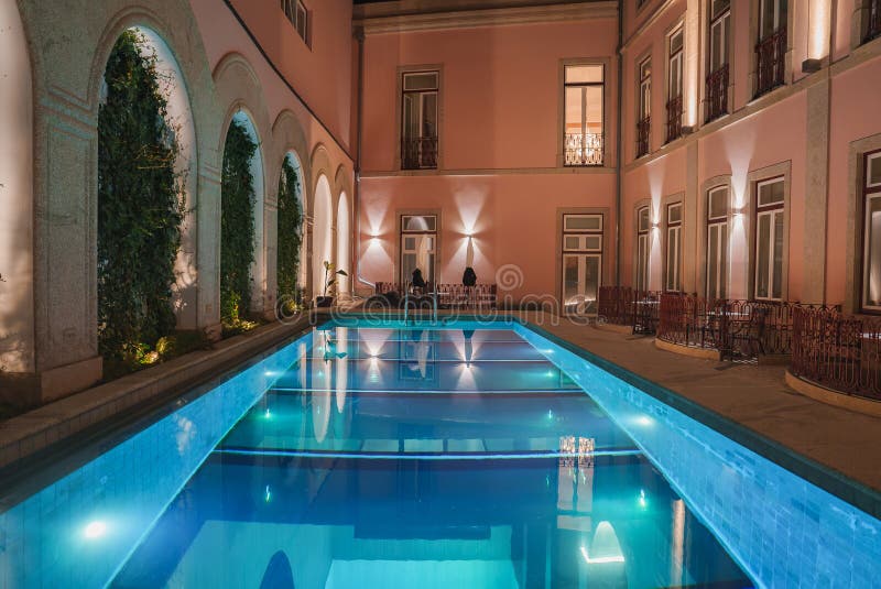Luxurious Hotel Courtyard with Illuminated Pool and Elegant ...