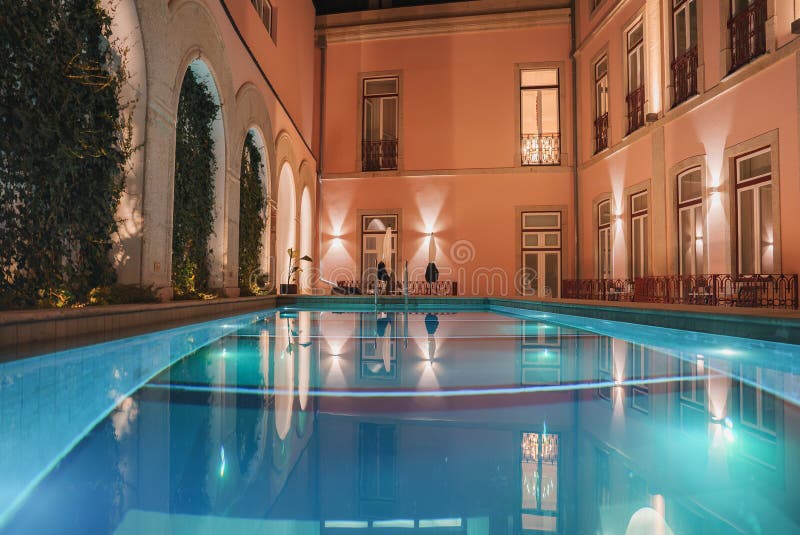 Luxurious Hotel Courtyard with Illuminated Swimming Pool at Night ...