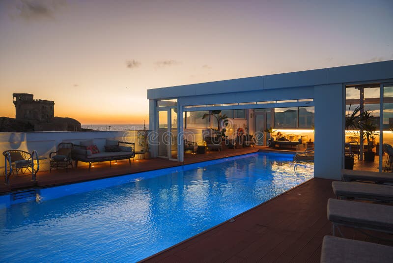 Luxurious Rooftop Pool at Sunset with Historic Tower in View Stock ...
