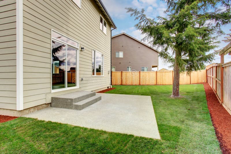 Luxury Back Yard with Unfurnished Patio and Grass. Stock Image - Image ...
