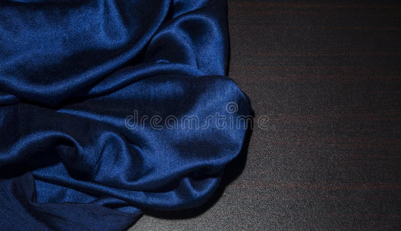 Luxury Blue Silk Fabric on Dark Brown Wood Table with Copy Space Stock ...