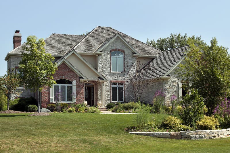 Luxury Brick Home with Stone Terrace Stock Photo - Image of driveway ...