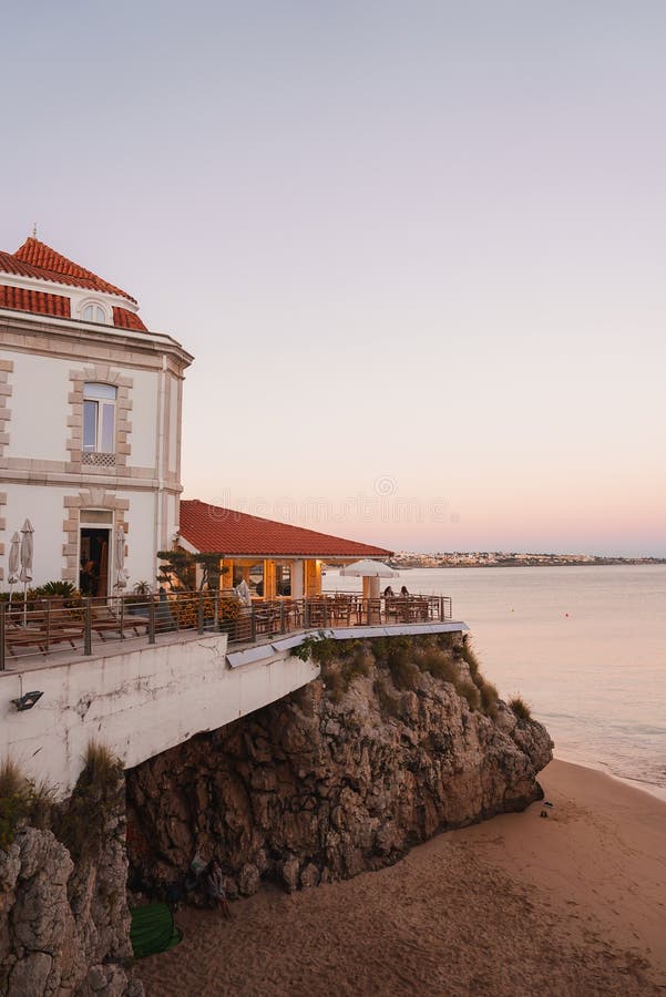 Luxury Hotel on Cliffside Overlooking Serene Beach at Sunset Stock ...