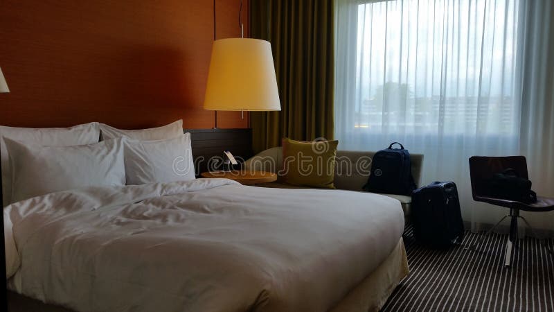 Luxury Hotel Room with a Warm Light, Bed and a Couch is Ready for ...