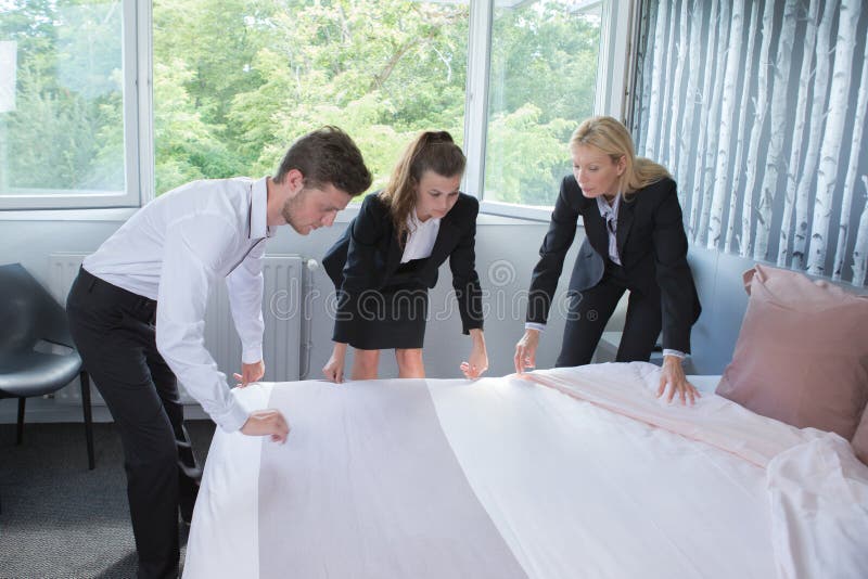 Luxury Hotel Team Servicing Bedroom Stock Photo - Image of girl ...