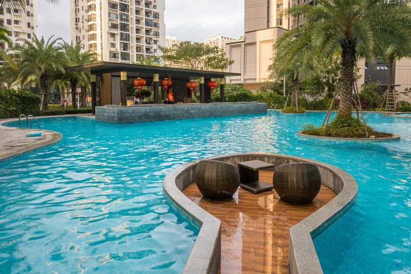 Luxury Poolside Patio with Wicker Chairs and Deck Stock Photo - Image ...