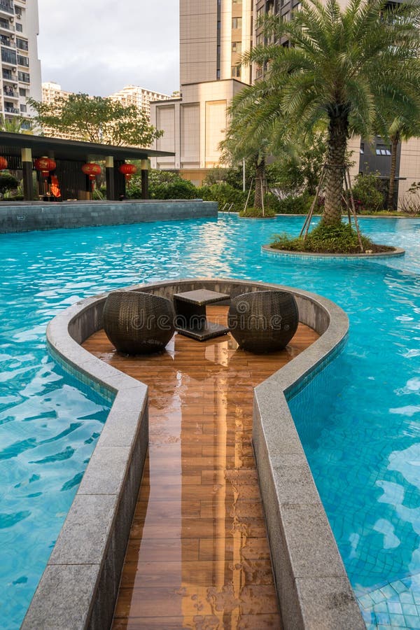 Luxury Poolside Patio with Wicker Chairs and Deck Stock Photo - Image ...