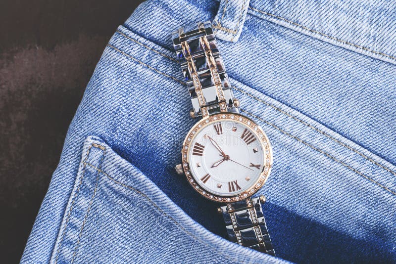 Luxury watch on blue jeans stock image. Image of automatic - 217893895