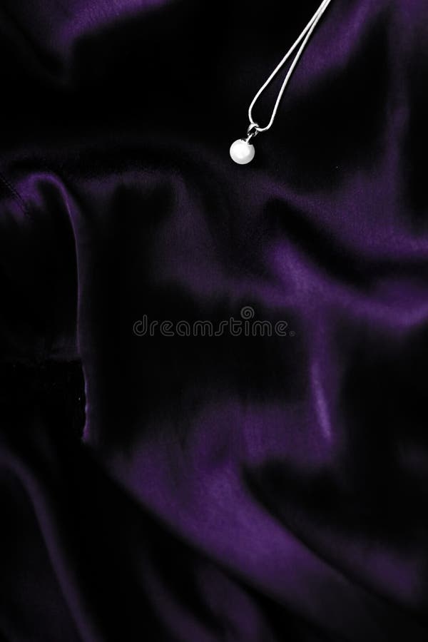 Luxury White Gold Pearl Necklace On Dark Violet Silk Background