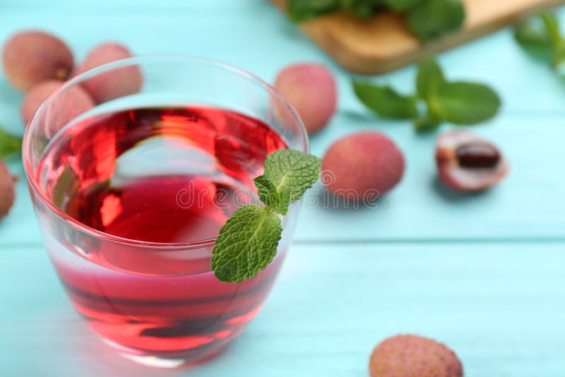 Lychee Cocktail with Mint on Cyan Table, Closeup Stock Photo - Image of ...