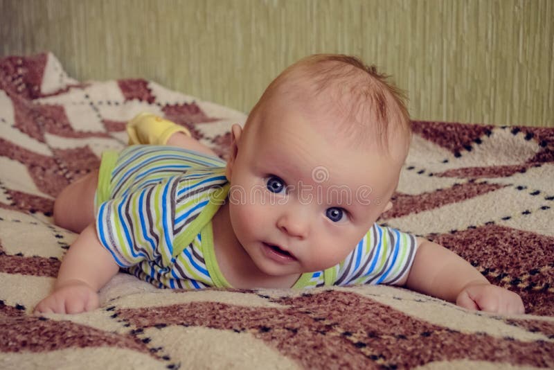 Lying Baby Looking with Curiosity Stock Image - Image of blue, adorable ...