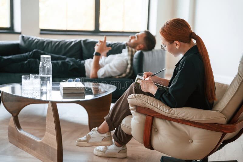 Lying Down on the Sofa. Man is on the Therapy Session with Female ...