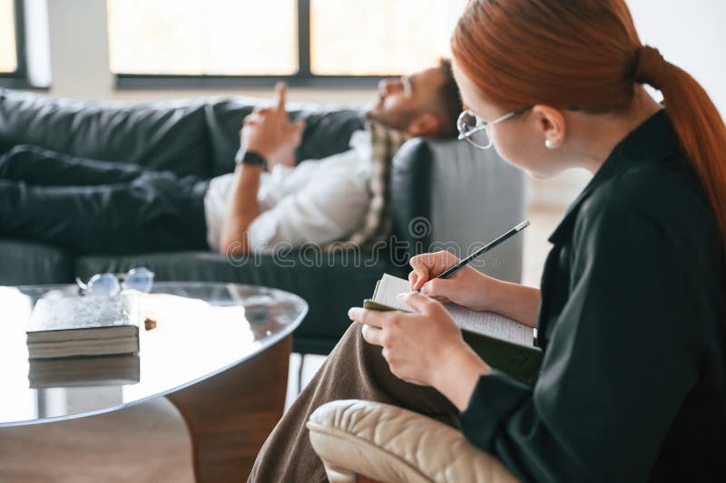 Lying Down on the Sofa. Man is on the Therapy Session with Female ...