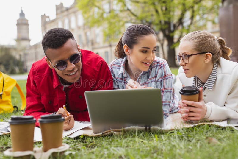 Three Good-looking Students Lying in the Grass Stock Photo - Image of ...