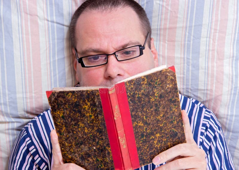Lying man reading a book stock photo. Image of literature - 49869020
