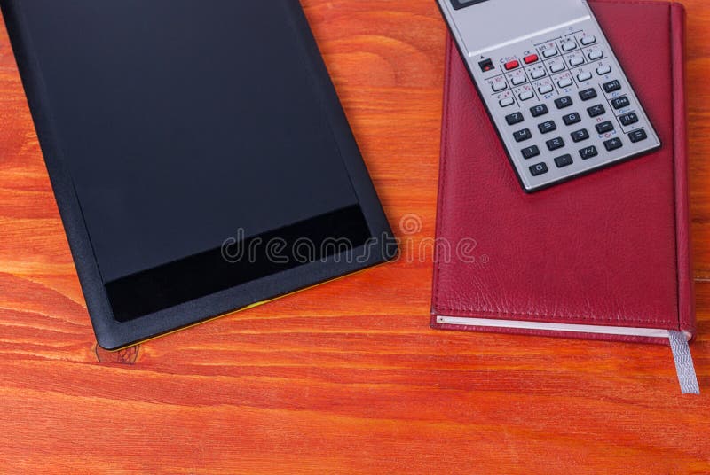 Lying on the Table Tablet, Calculator and Red Notebook Stock Photo ...