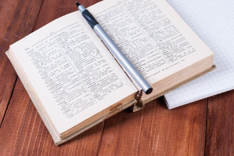 Lying on a Wooden Table Dictionary, Pen and Notebook Stock Image ...