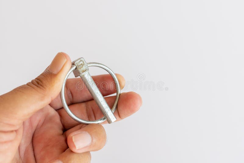 Lynch Pin Holding in Hand on a White Background with Selective Focus ...