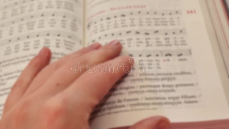 Lyrics and Notes. Hand Flips through the Pages of a Songbook with Notes ...