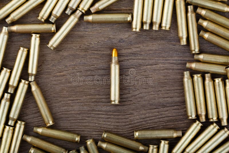 M-16 Bullet on Wooden Table Close-up. Stock Image - Image of copper ...