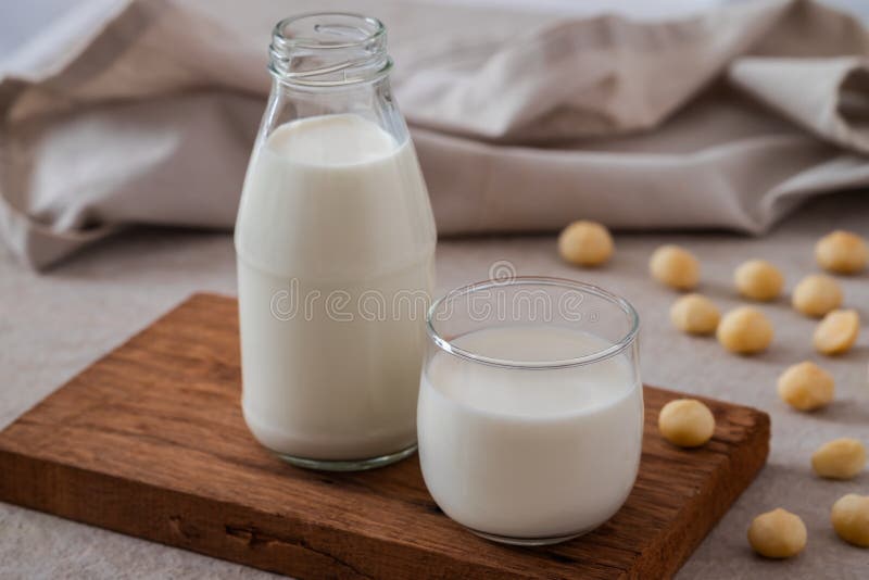 Macadamia Milk in Glass and Bottle of Macadamia Milk on Wooden Board ...