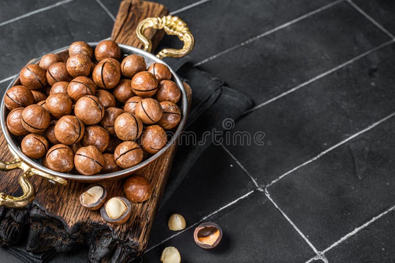 Macadamia Nuts in a Shell Ready To Eat. Black Background. Top View ...