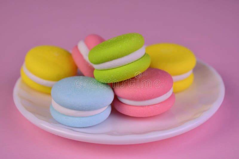 Macaron Shaped Candies on a White Plate. Close-up. Stock Photo - Image ...